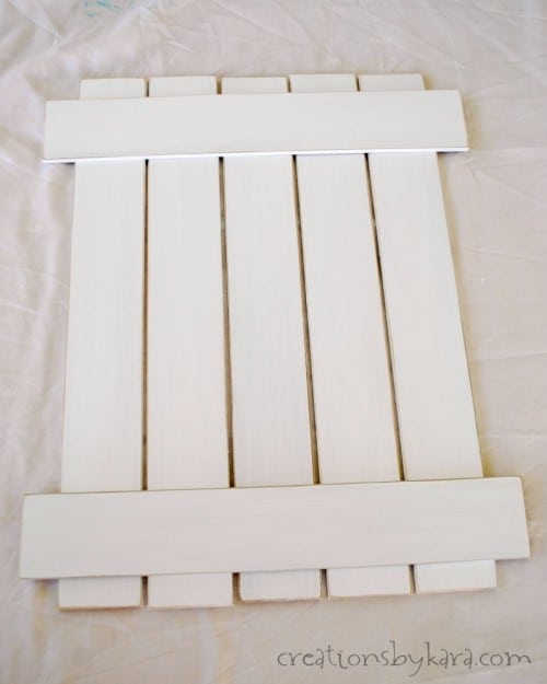 DIY white picket fence sign with hanging wreath